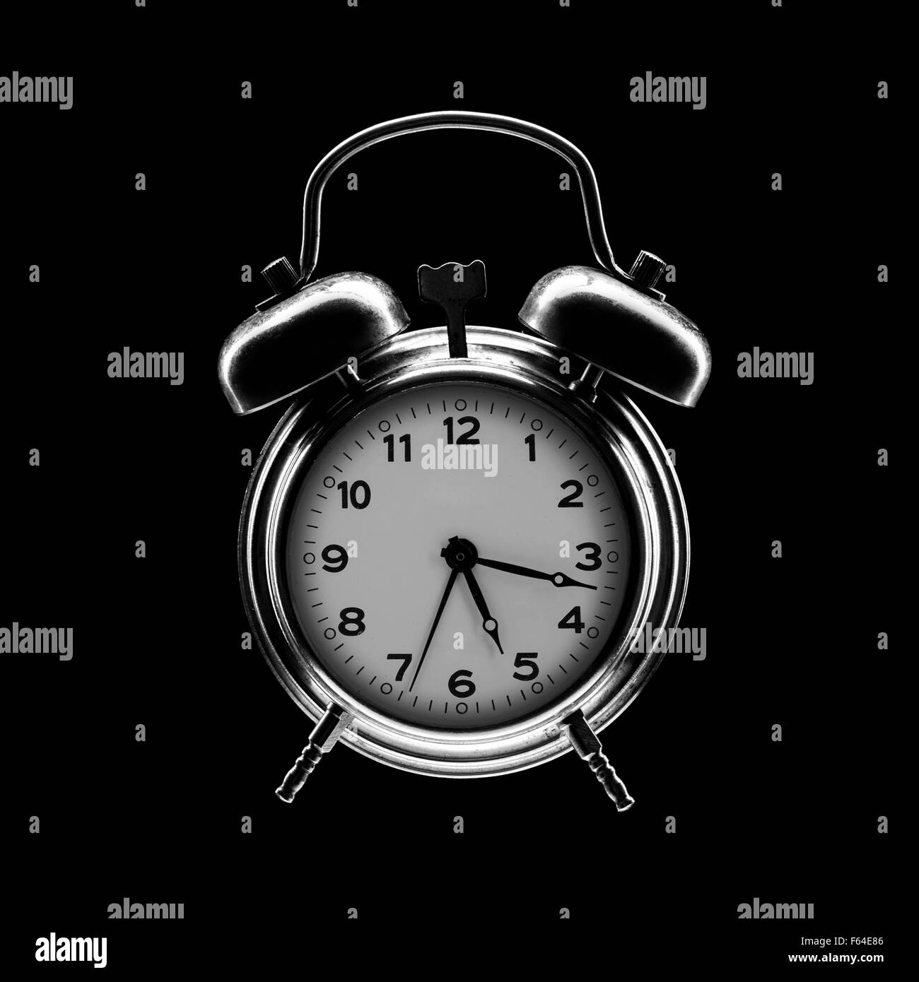 Classical alarm clock isolated on black Stock Photo - Alamy