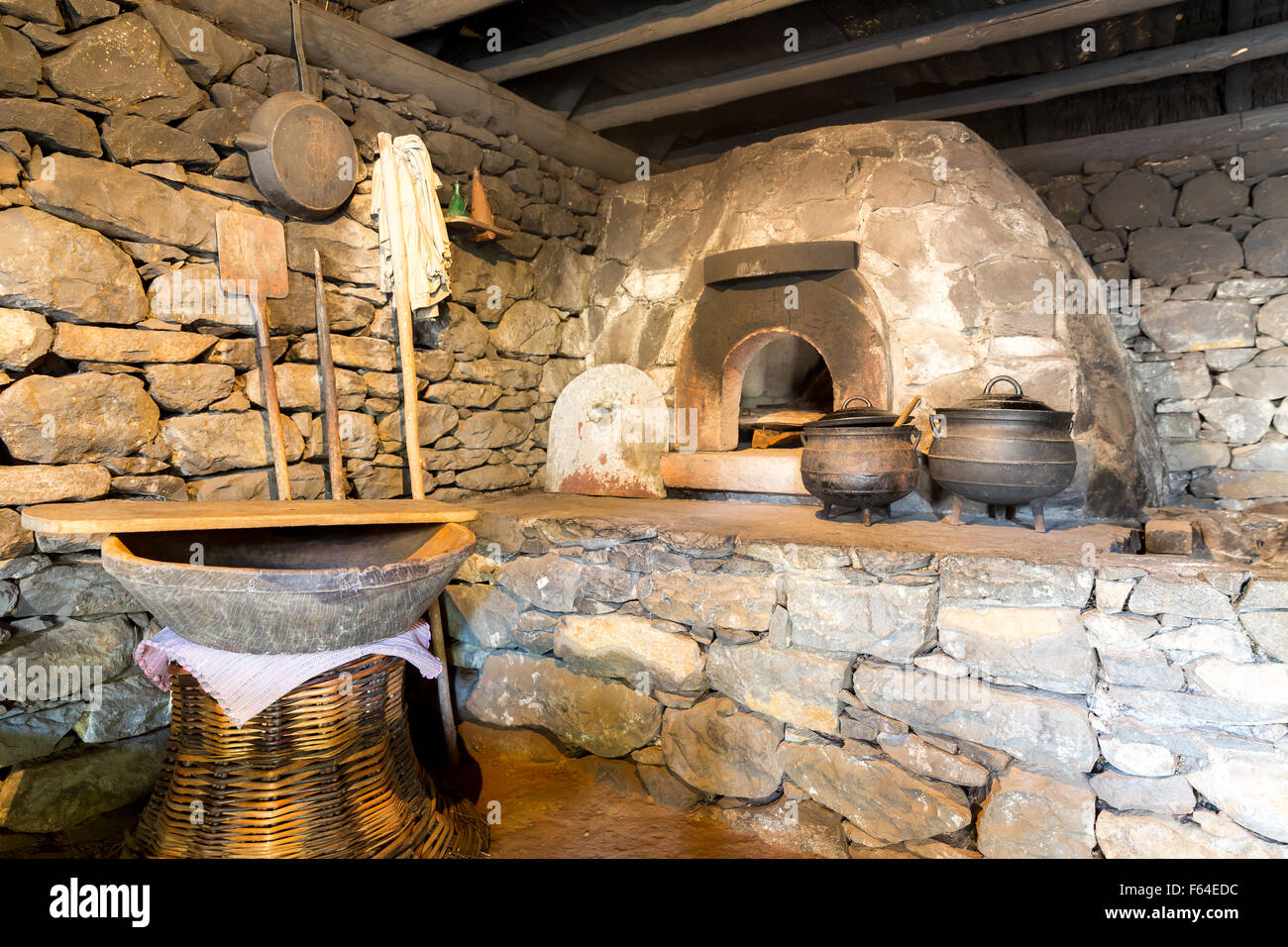 Old kitchen interior with furnace, pots and lumber Stock Photo - Alamy