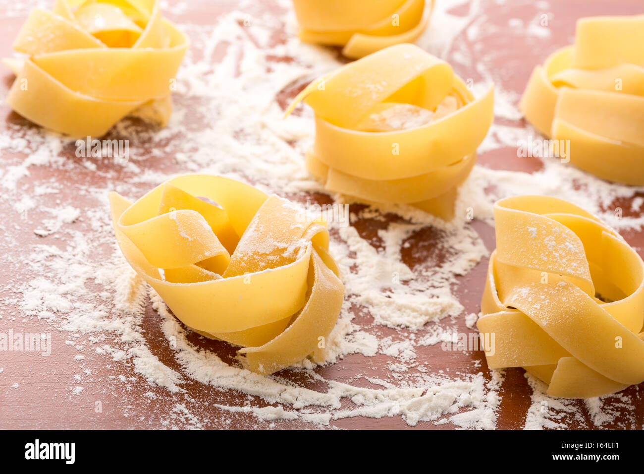 Closeup of pasta rolls on the floured table Stock Photo - Alamy