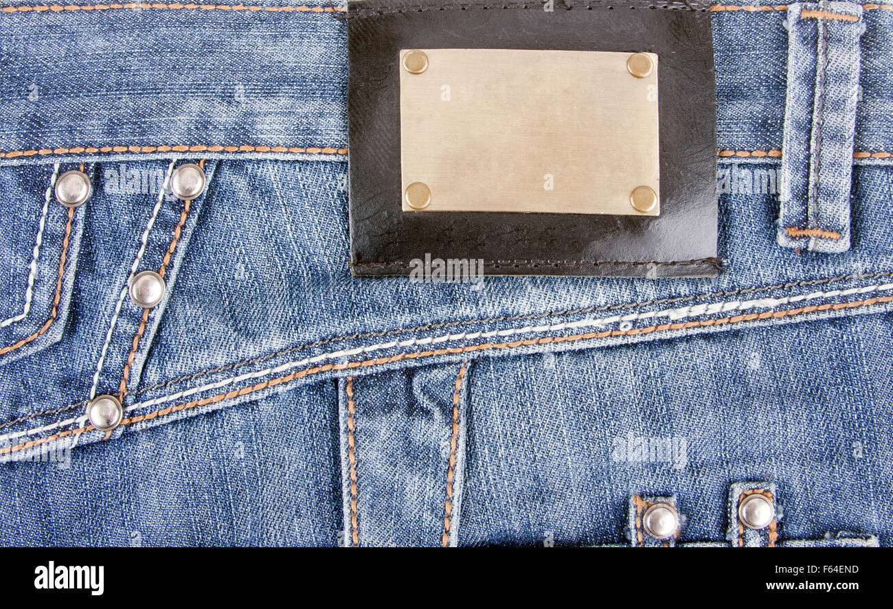 Close-up of blue jeans with bronze label Stock Photo - Alamy