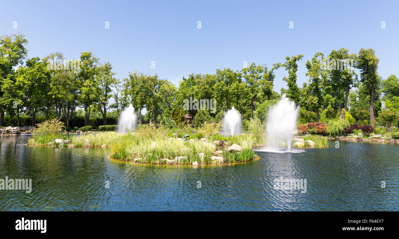 Beautiful pond in spring park with fountains Stock Photo - Alamy