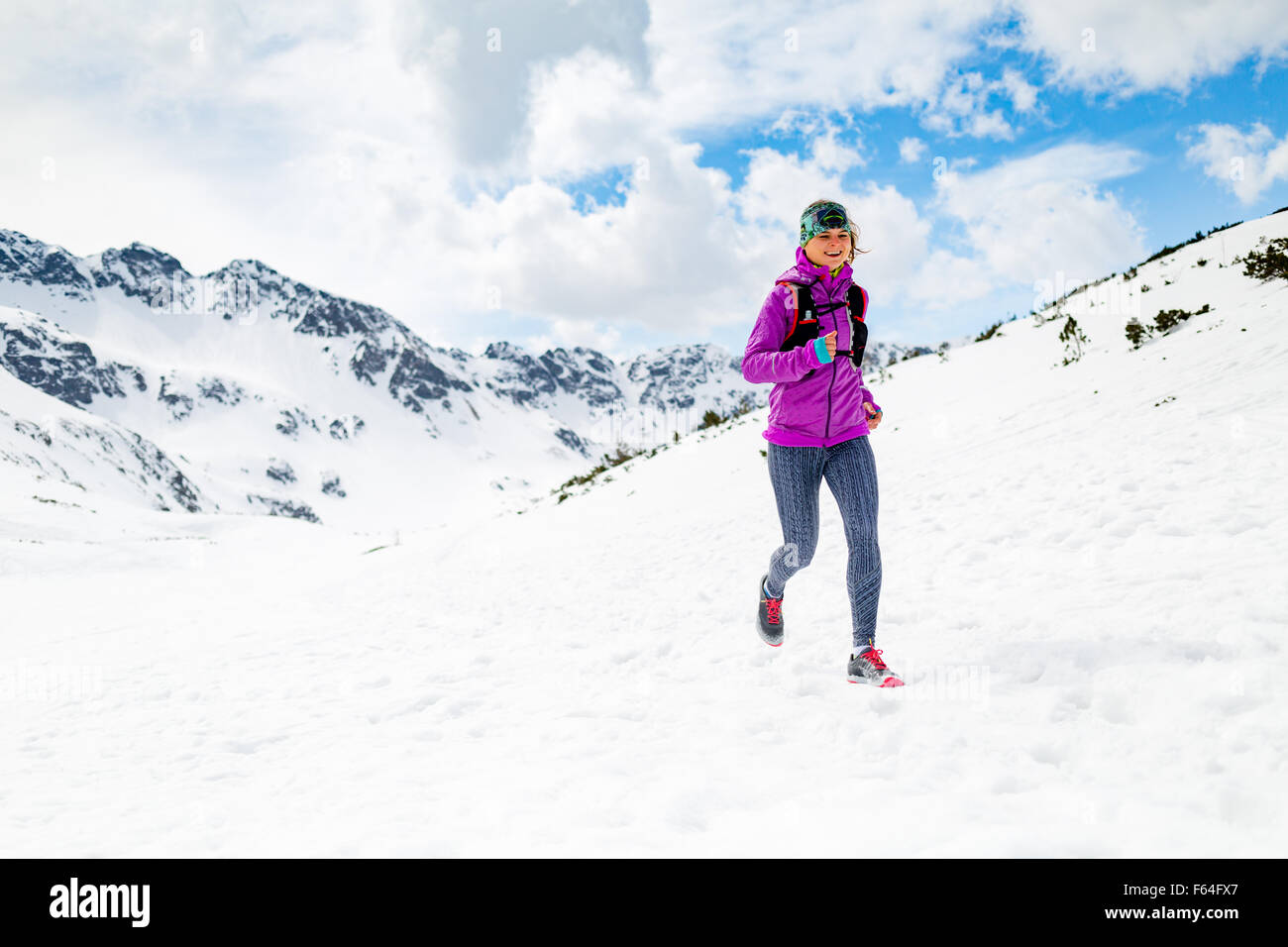 Trail running woman runner in white winter mountains on snow ...