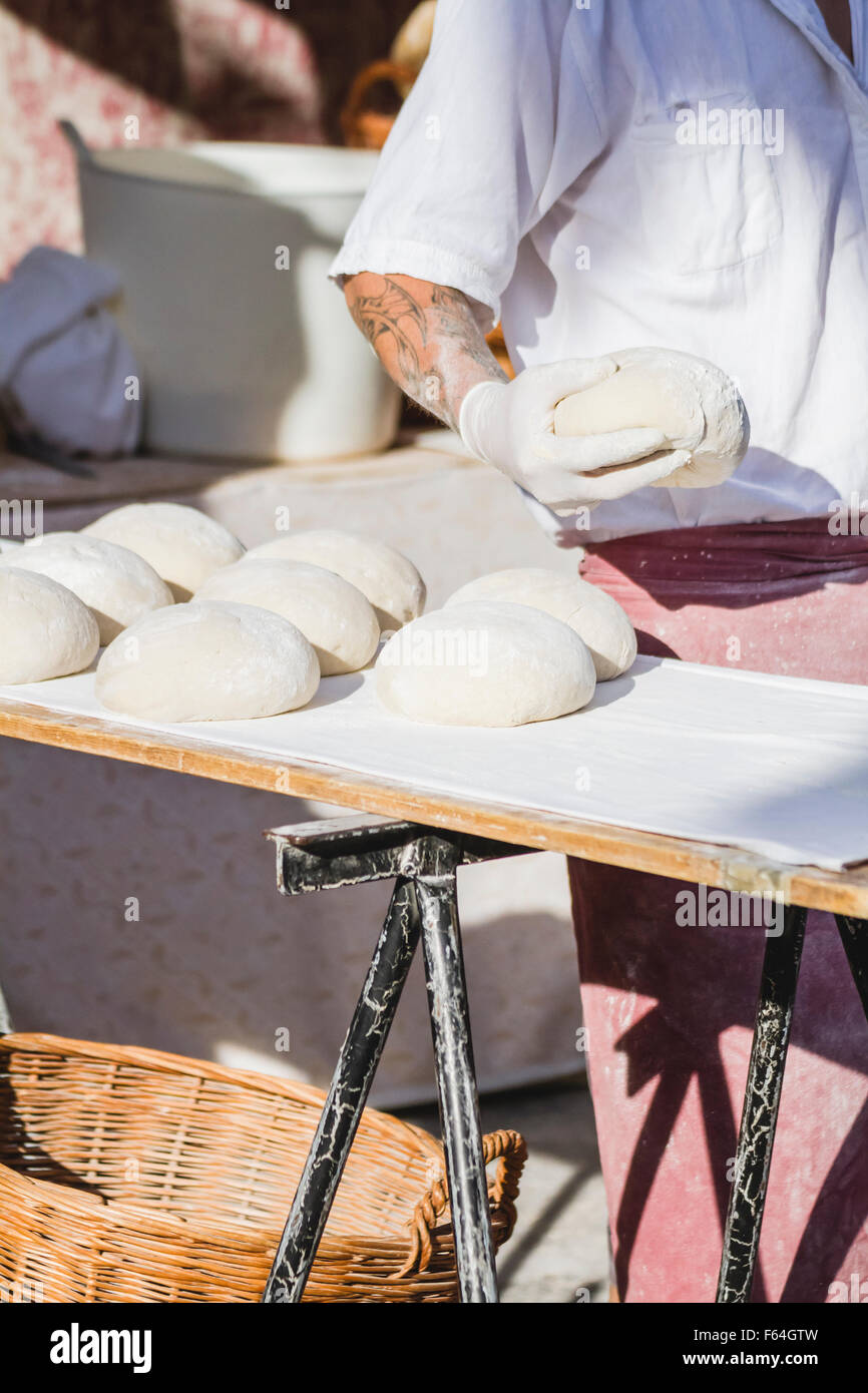 Baker making artisan bread in a medieval fair Stock Photo - Alamy