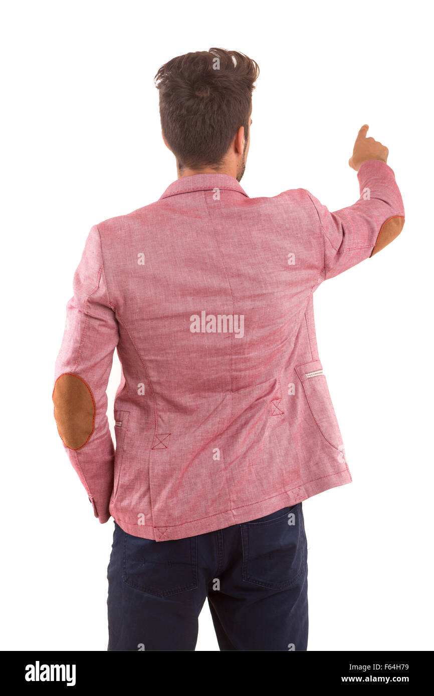 A young man with his back turned to camera, pointing to something Stock ...
