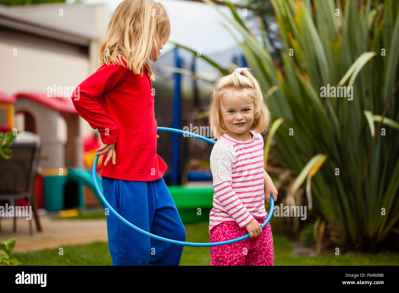 Two little girls in a hula hoop Stock Photo - Alamy