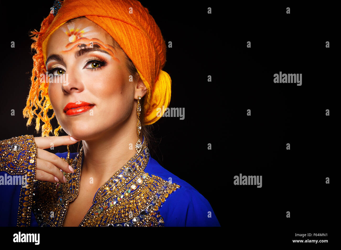 Portrait of eastern beauty with face art and national costumes. Girl ...