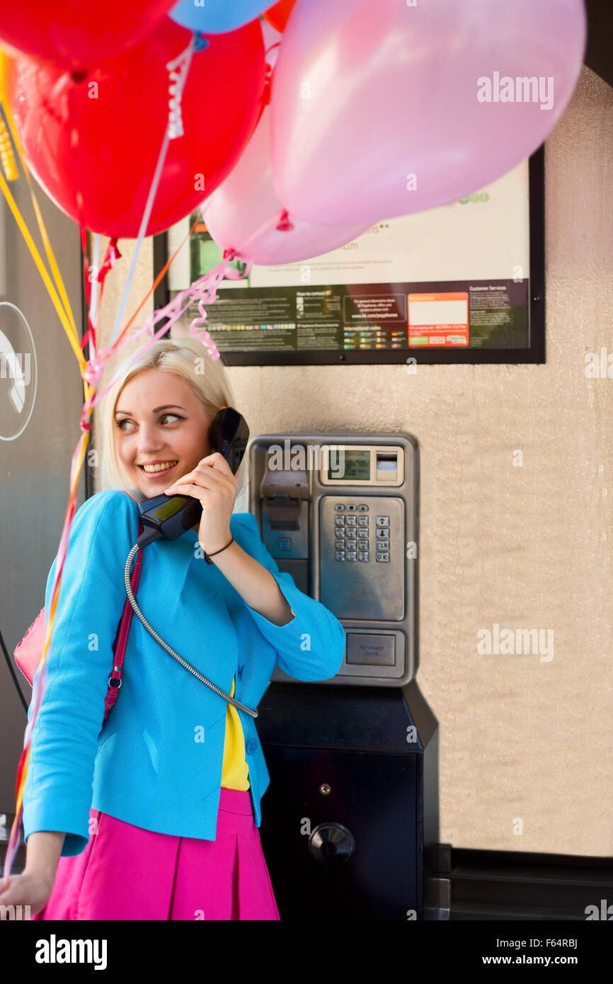 party girl talking on the phone with a bunch of balloons Stock Photo ...