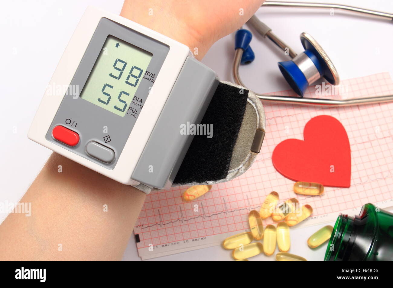 Measuring blood pressure, heart shape, stethoscope and tablets on ...