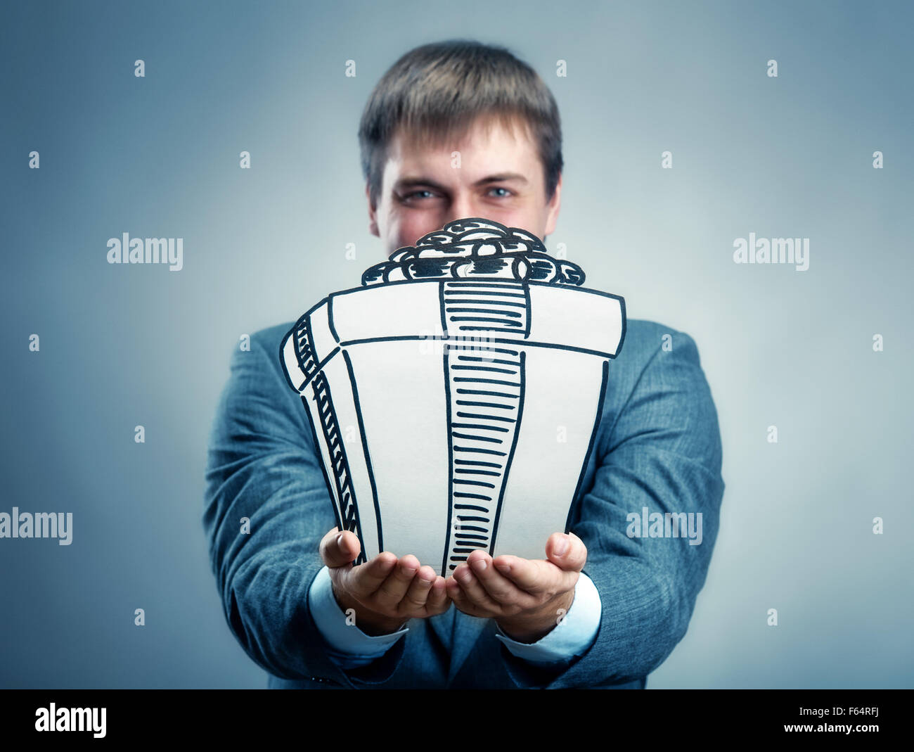 Young businessman holding big paper gift box Stock Photo - Alamy