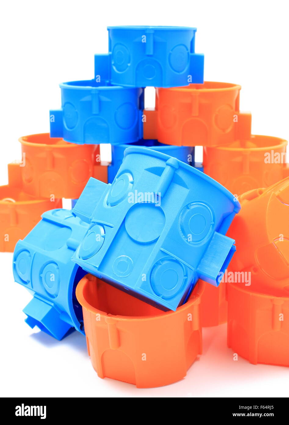 Blue and orange plastic electrical boxes on white background ...