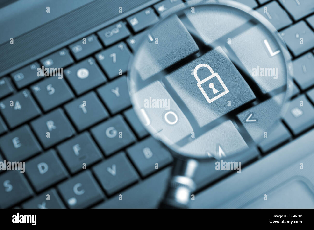 Magnifying glass focused on lock icon Stock Photo - Alamy