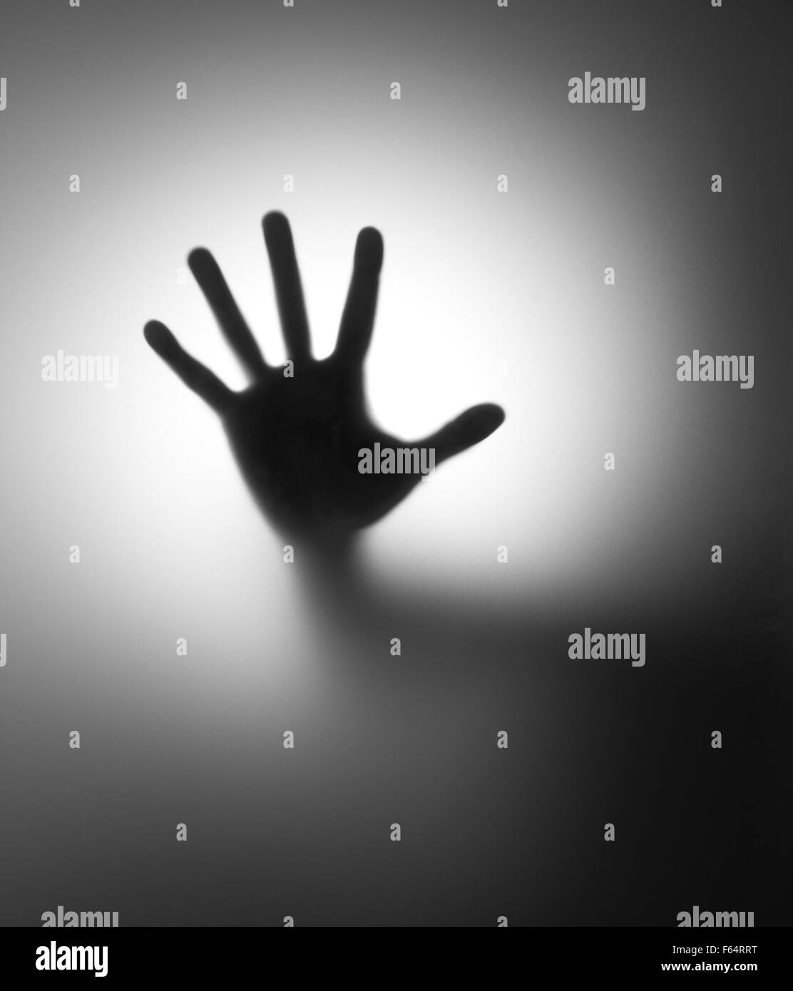 Hand behind glass Black and White Stock Photos & Images - Alamy