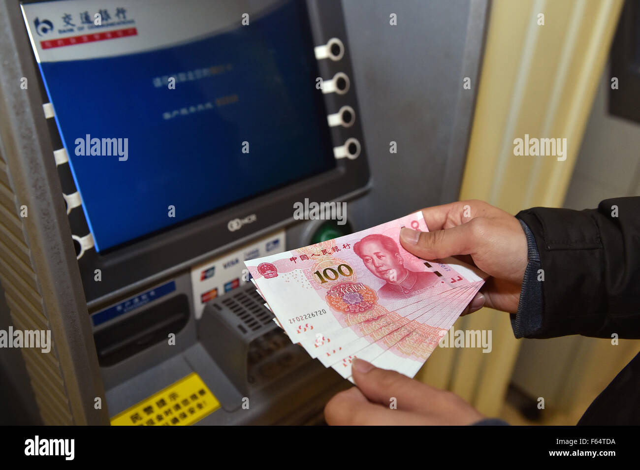 Beijing, China. 12th Nov, 2015. A resident withdraws new 100-yuan ...