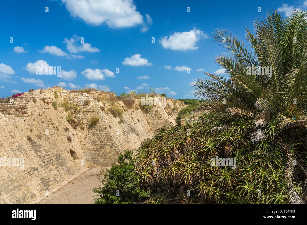 The walls and moat of the ruins of Caesarea in the Caesarea National ...