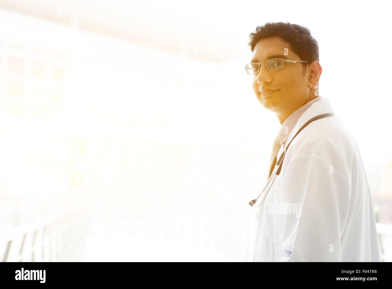 Portrait of Asian Indian medical doctor walking outside hospital ...