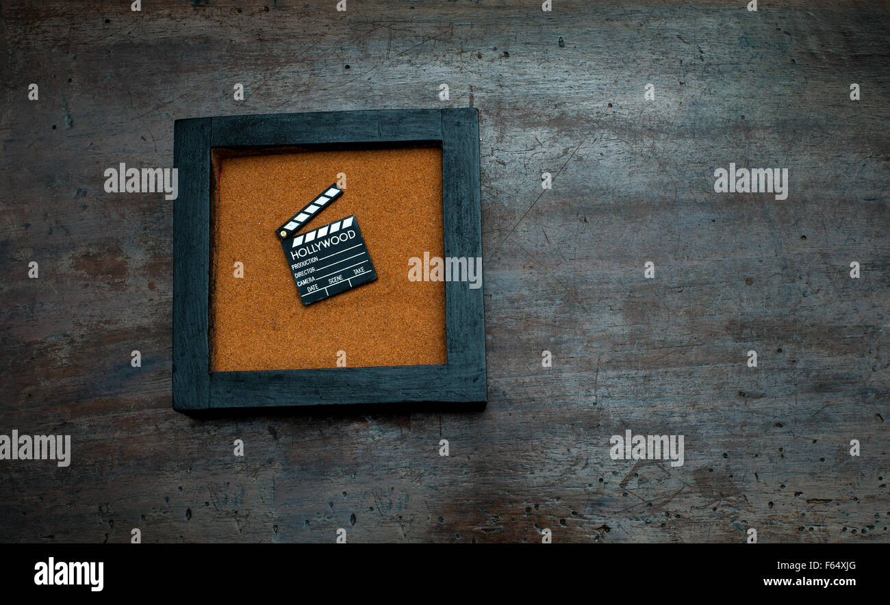 Zen garden with movie clapper board, orange sand on aged scraped wood ...