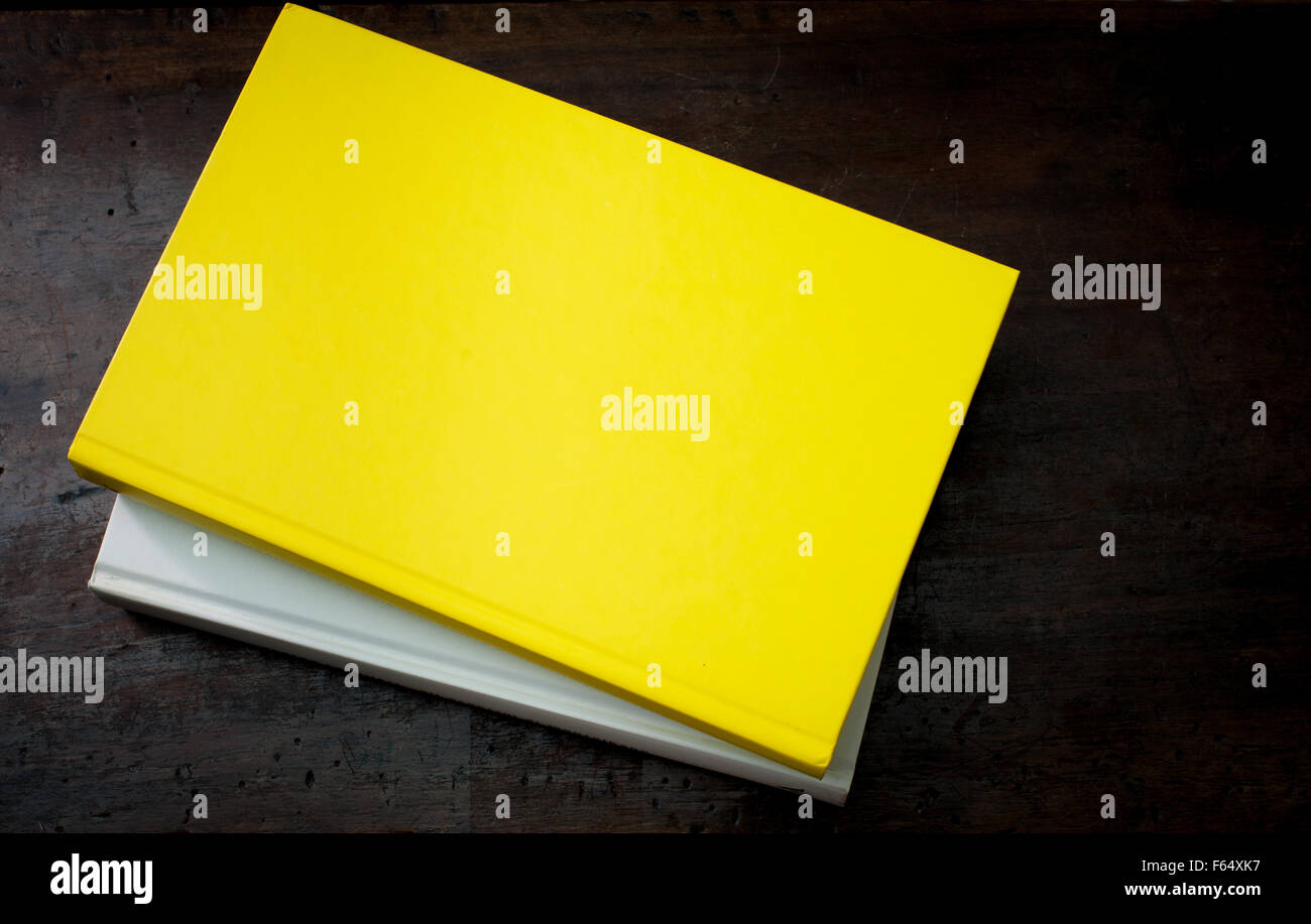 Aged books yellow empty cover on scraped wooden table Stock Photo - Alamy