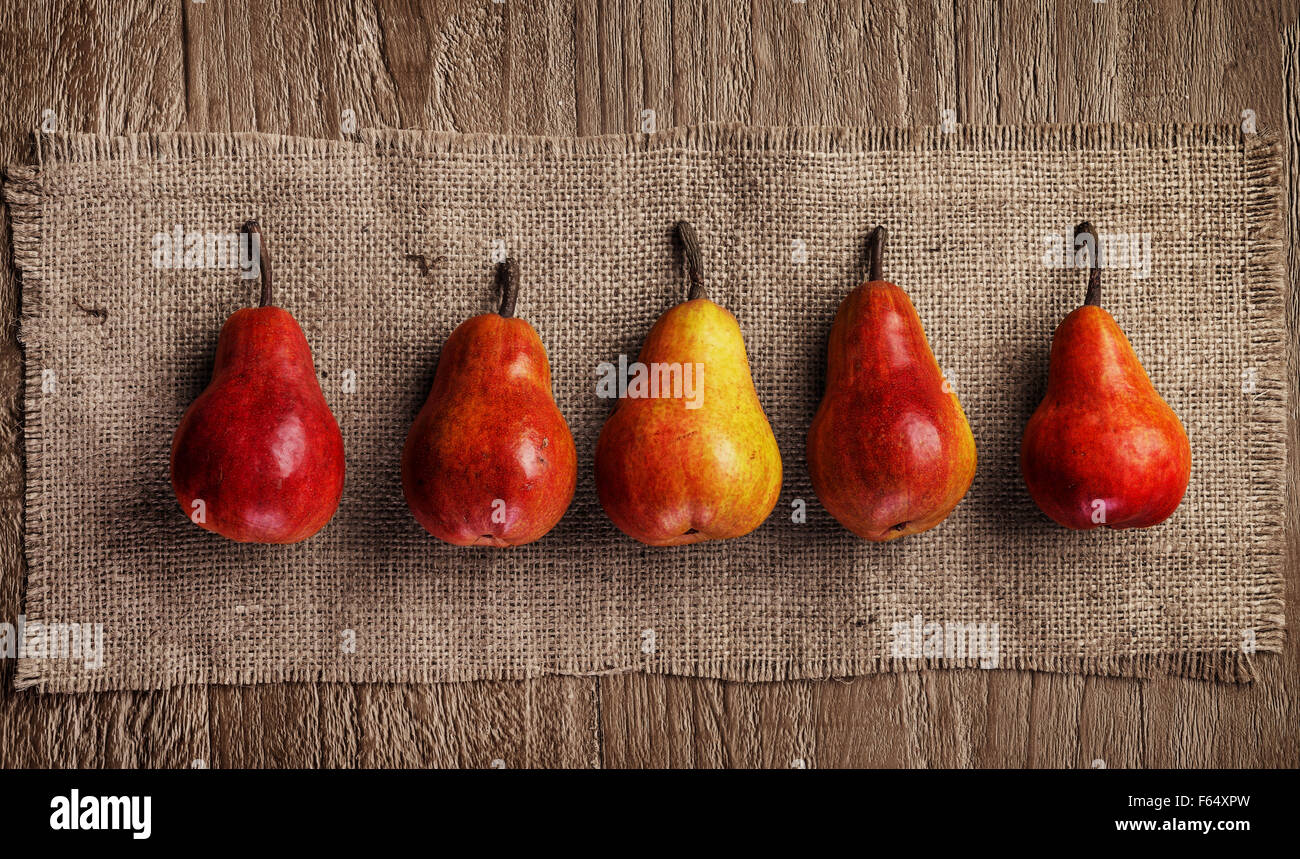 four colorful pears closeup on vintage wooden table Stock Photo - Alamy