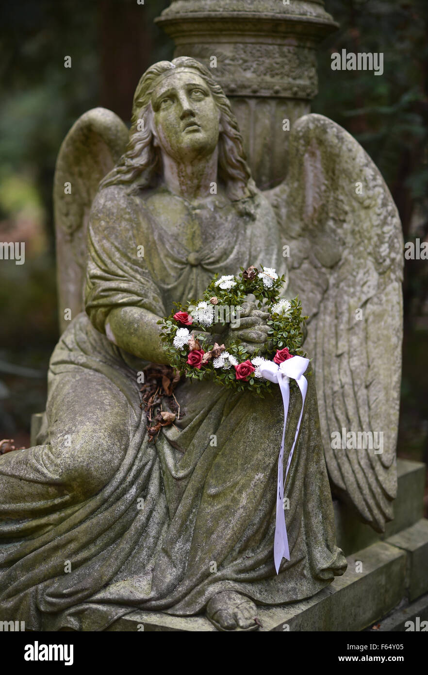 A grieving angel with a floral wreath adorns a grave in the Main ...