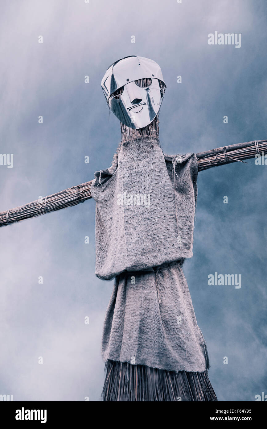 a scarecrow with a modern mask Stock Photo - Alamy