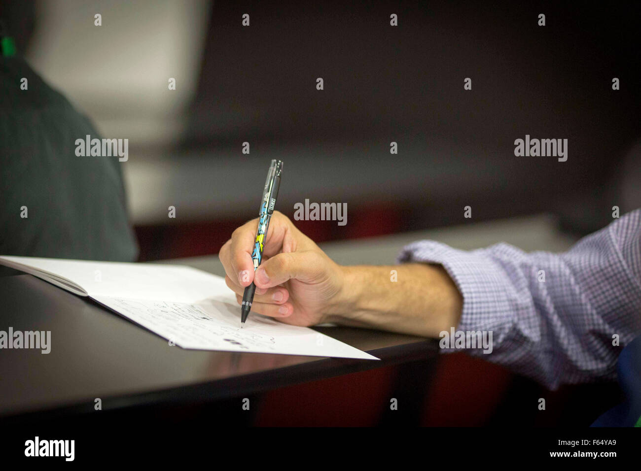 a man doodles on a piece of paper Stock Photo - Alamy
