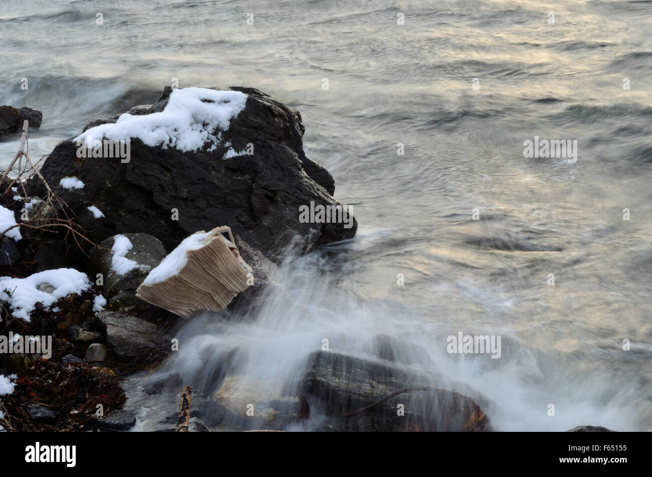 cold sea waves hitting rocky sea shore Stock Photo - Alamy