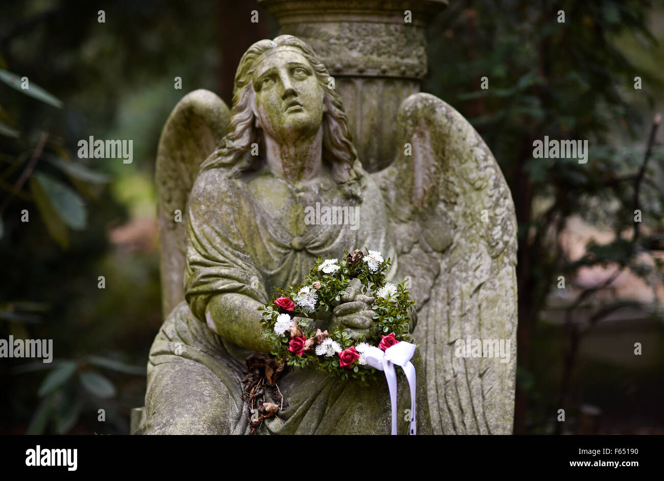 A grieving angel and a floral wreath adorn a grave in the Main Cemetery ...