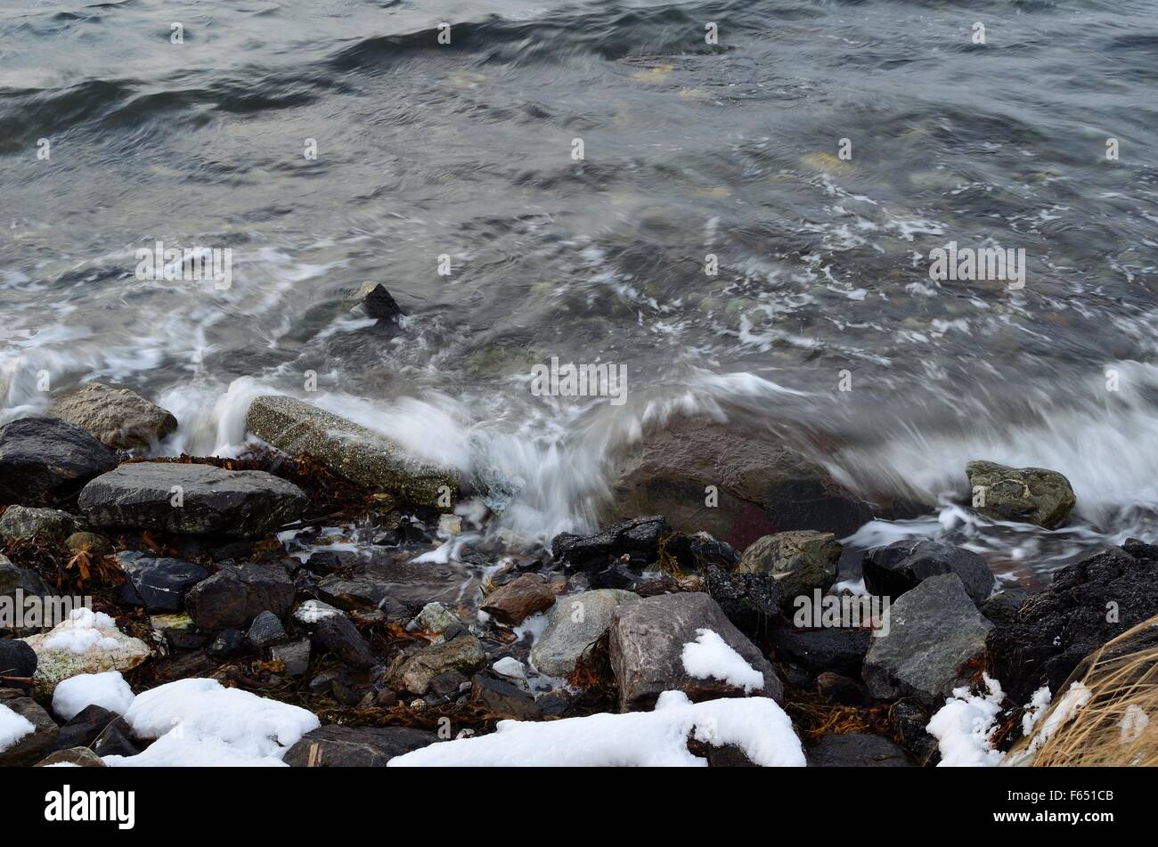 cold sea waves hitting rocky sea shore Stock Photo - Alamy