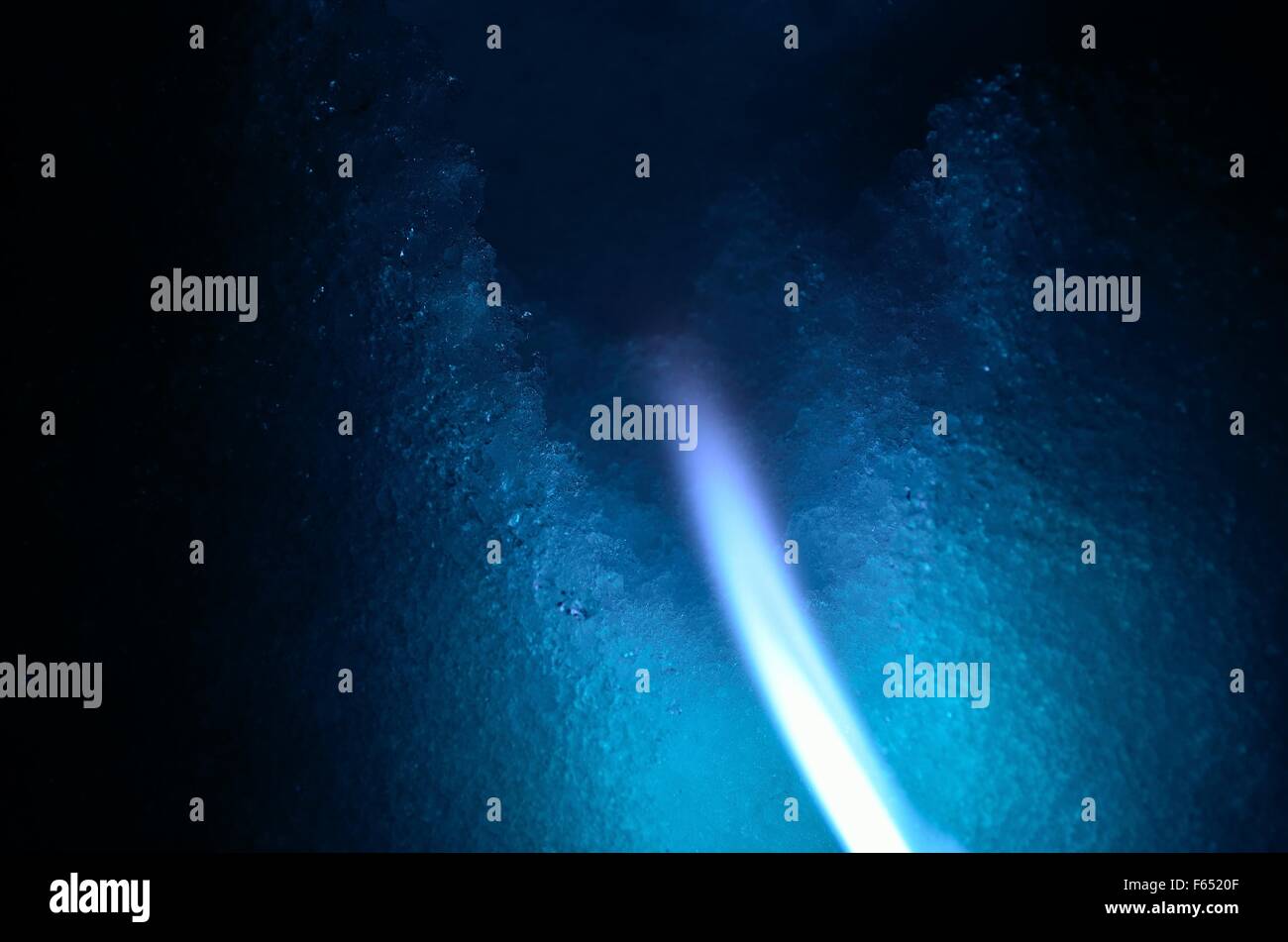 blue gas jet flame melting snow in winter night macro photo Stock Photo ...