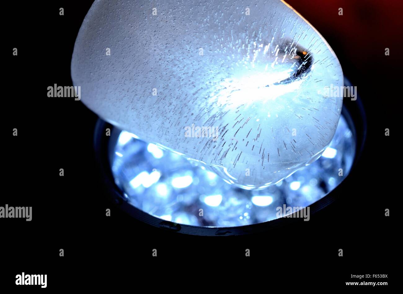 melting ice cube on led flashlight Stock Photo - Alamy
