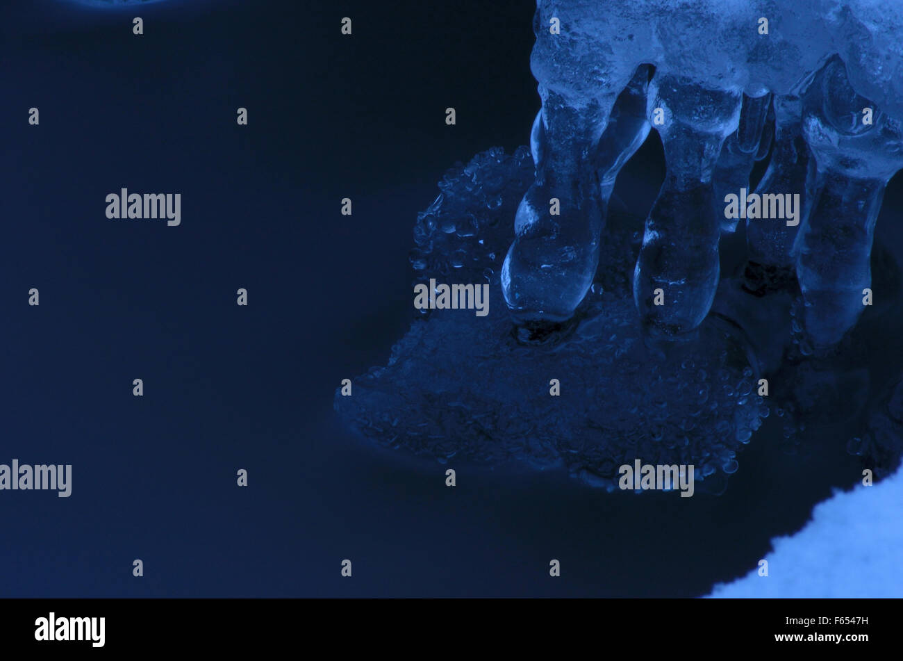 hole in river ice in winter and beautiful frozen ice shapes and water ...