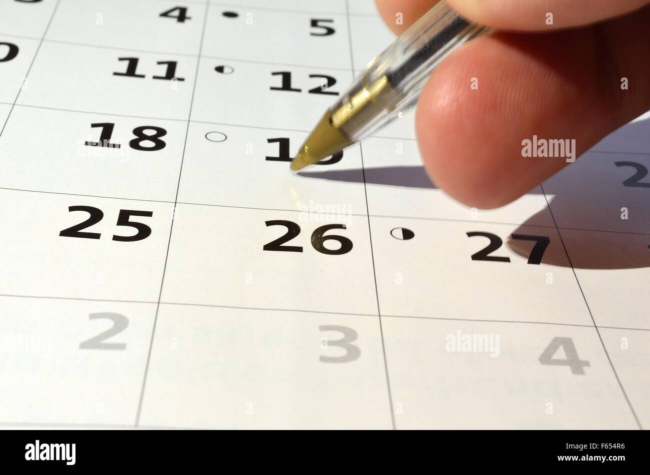 human hand marks a day on an blank white calendar Stock Photo - Alamy