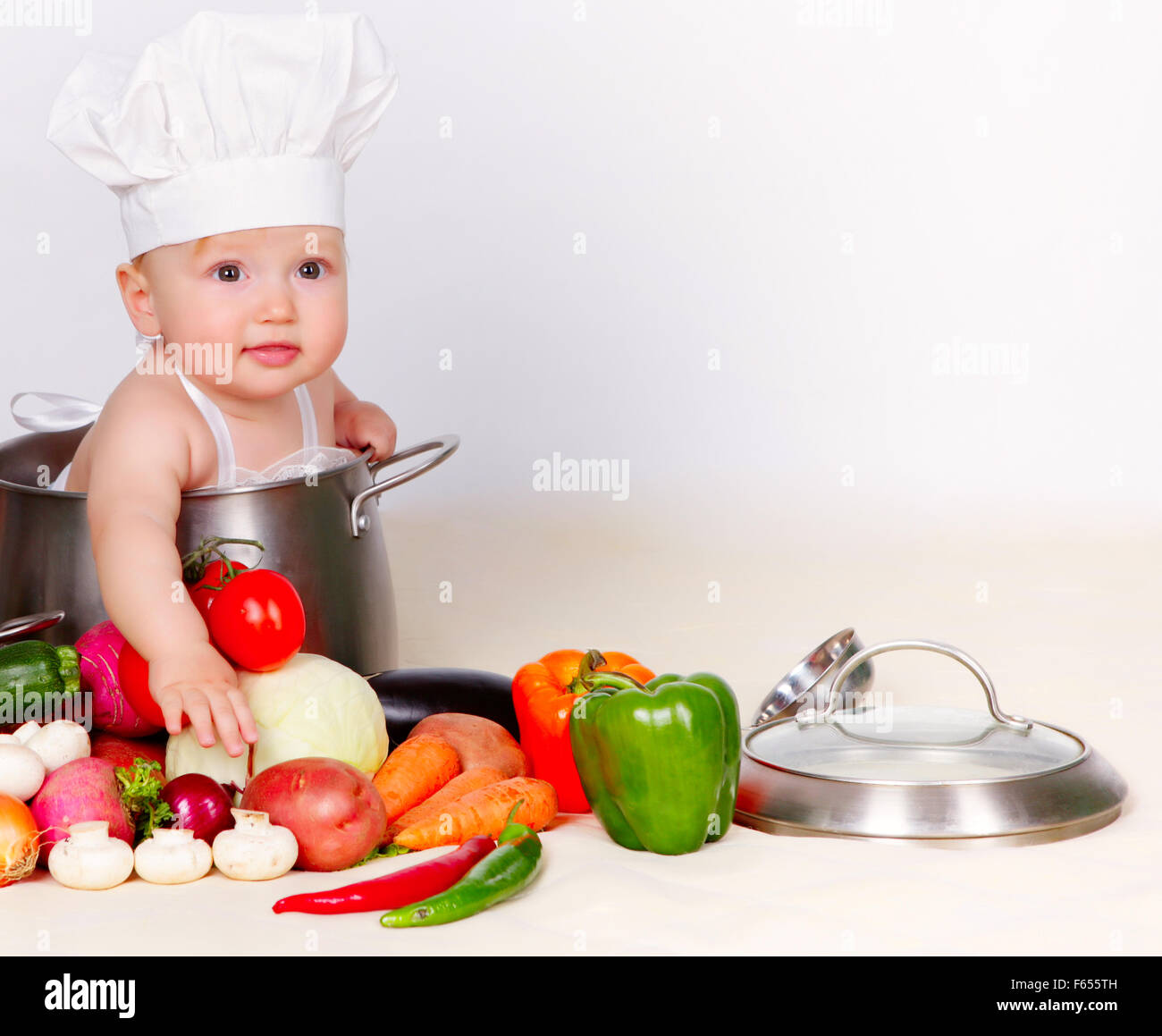 Baby cook in saucepan Stock Photo - Alamy