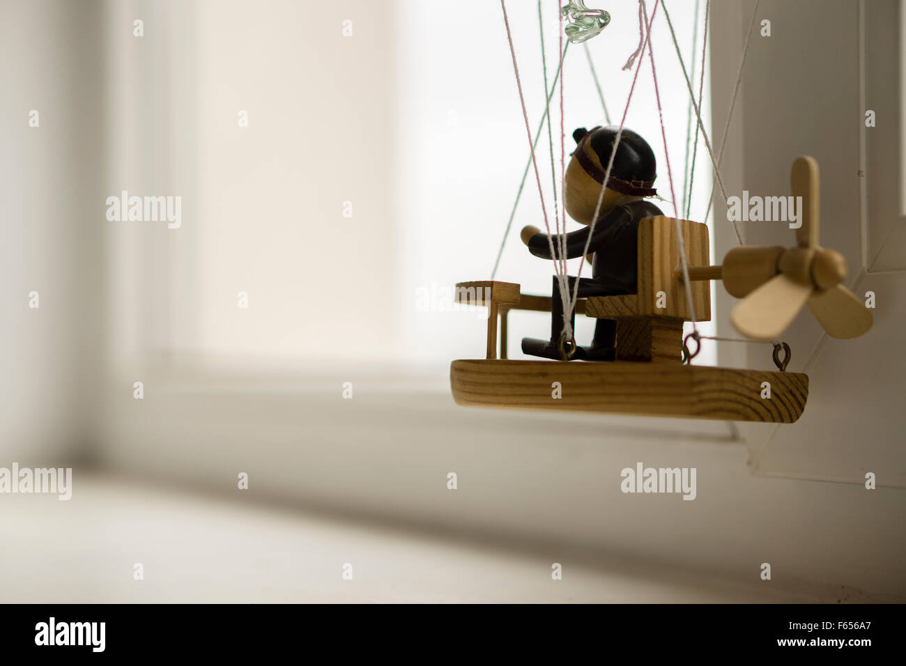 Wooden puppet in a balloon, looking out the window Stock Photo - Alamy