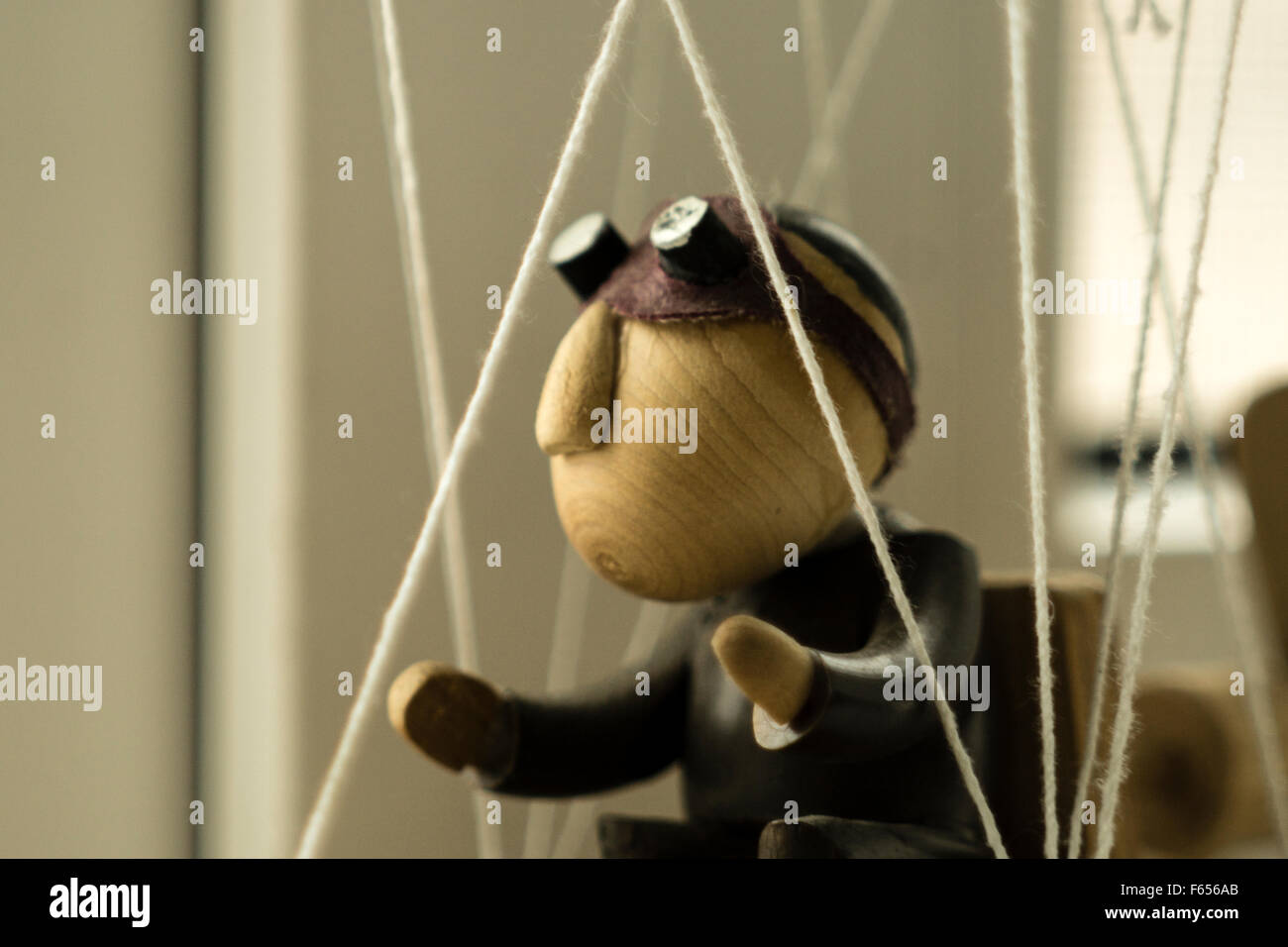 Wooden puppet in a balloon, looking out the window Stock Photo - Alamy