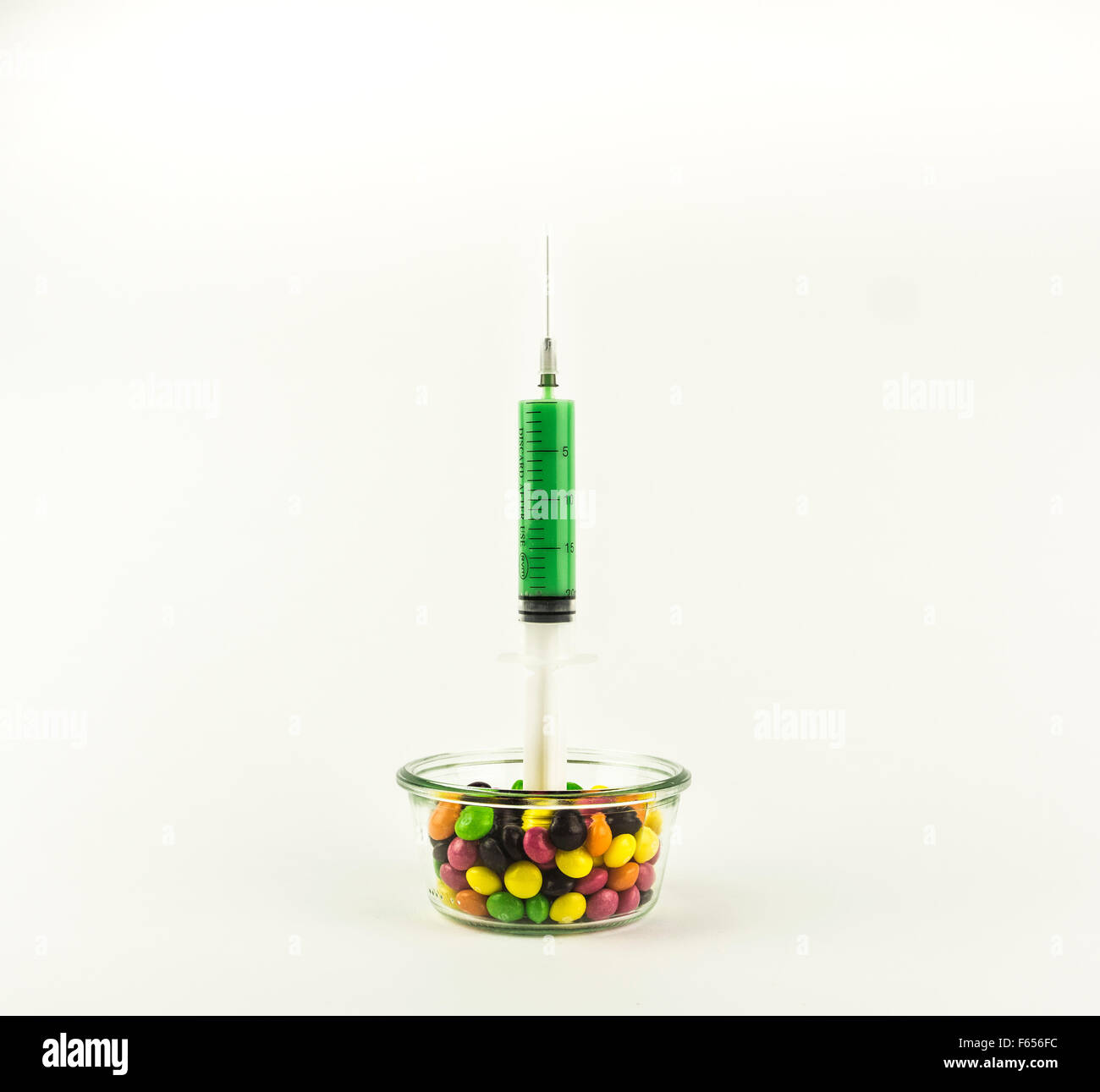 Colourful syringe in a jar with candy Stock Photo - Alamy