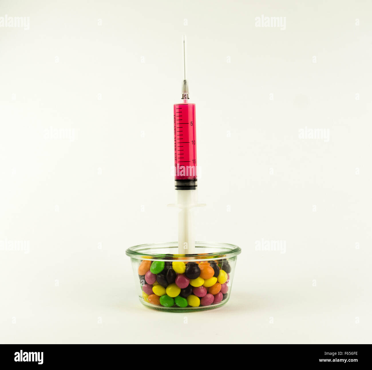 Colourful syringe in a jar with candy Stock Photo - Alamy