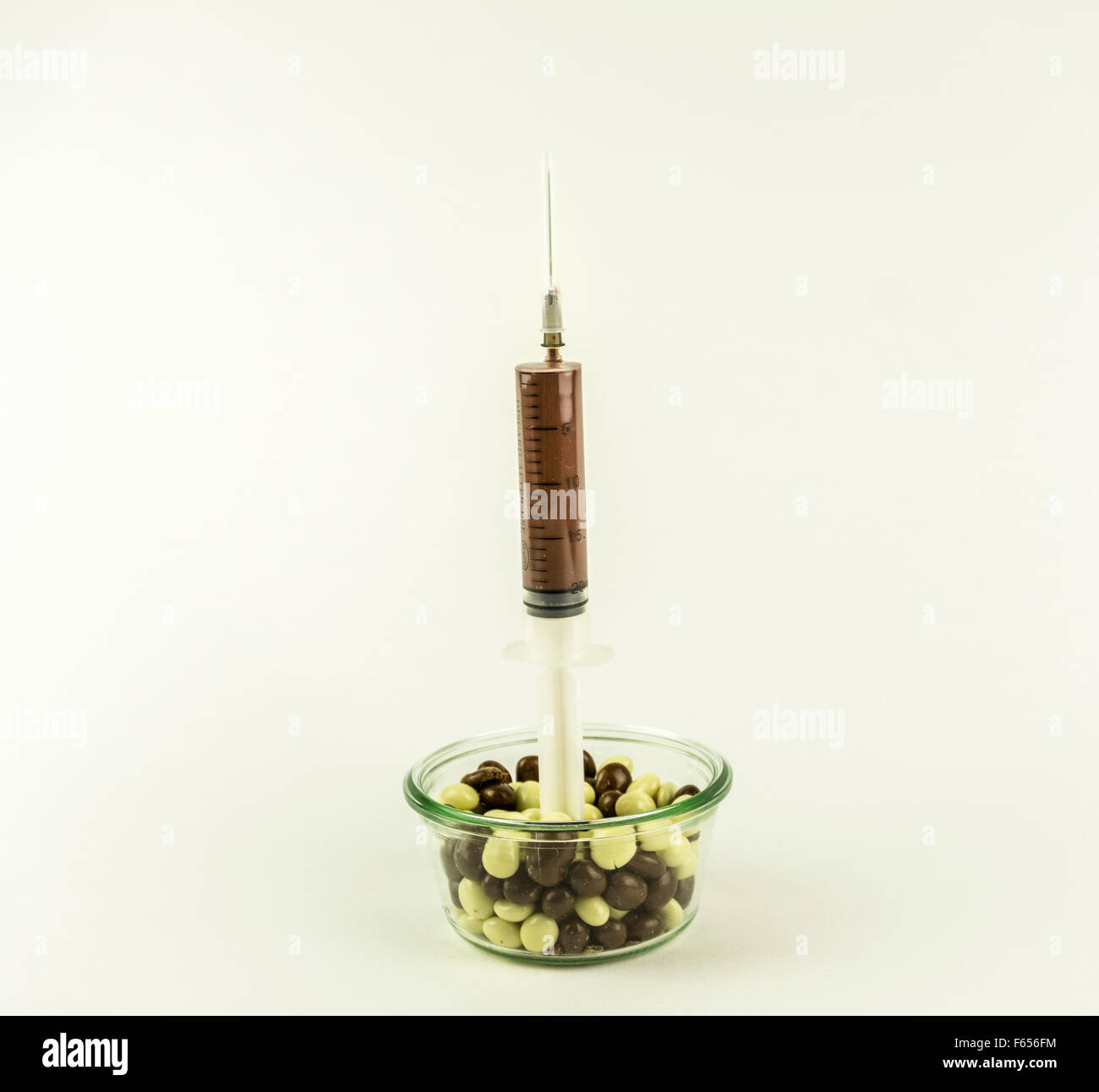 Colourful syringe in a jar with candy Stock Photo - Alamy