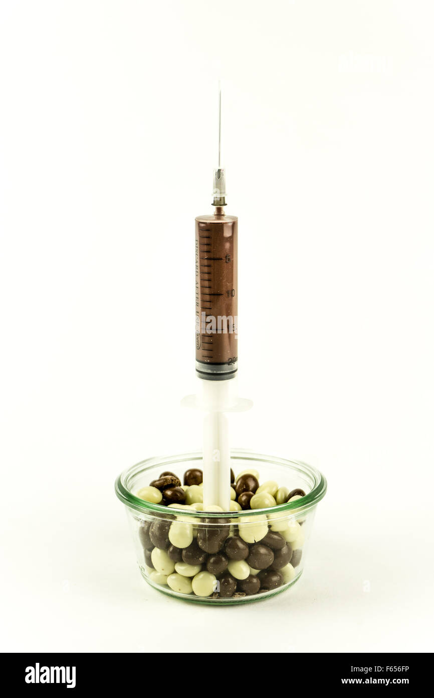 Colourful syringe in a jar with candy Stock Photo - Alamy