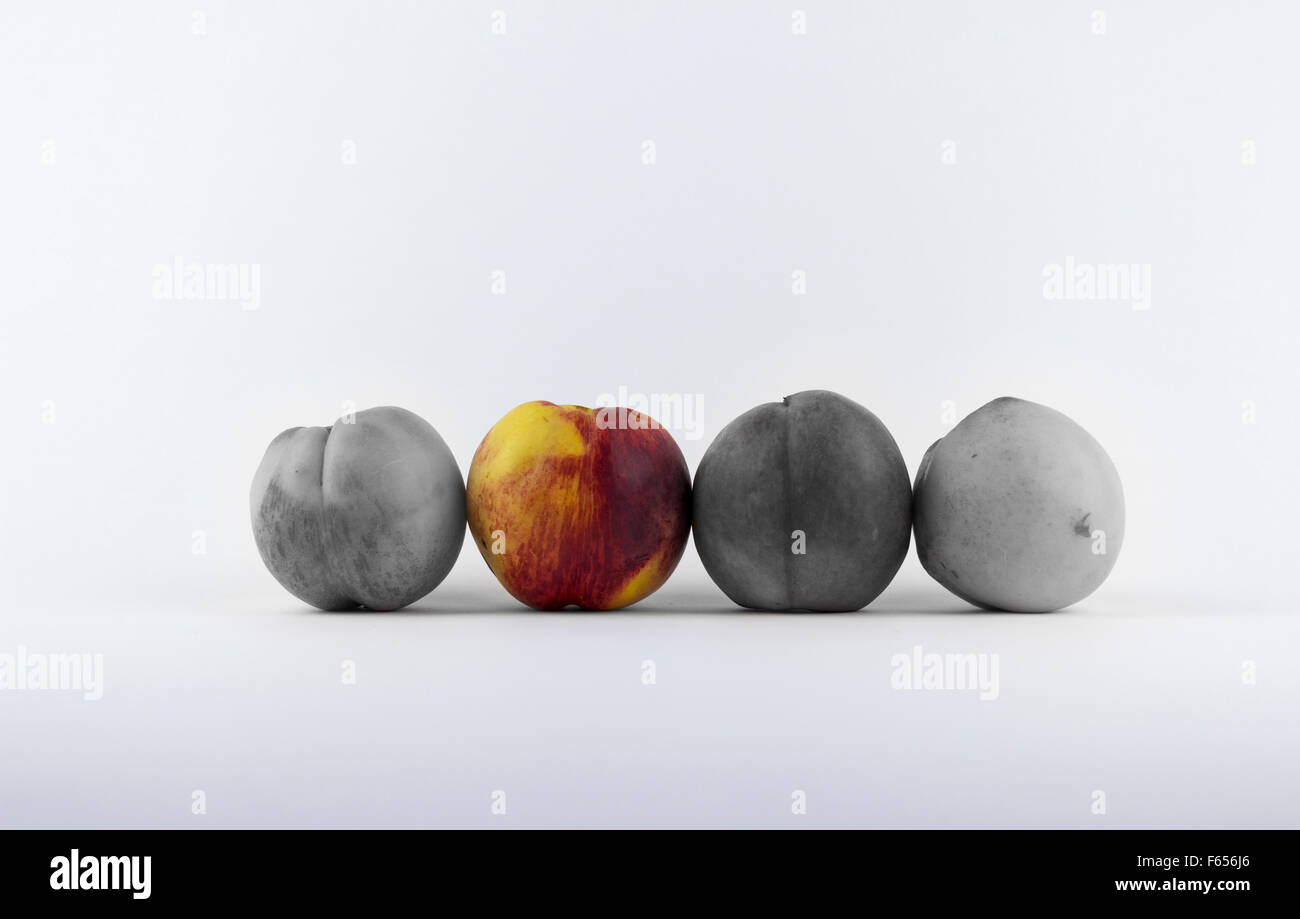 Four peaches on a white background, one coloured and the rest ...