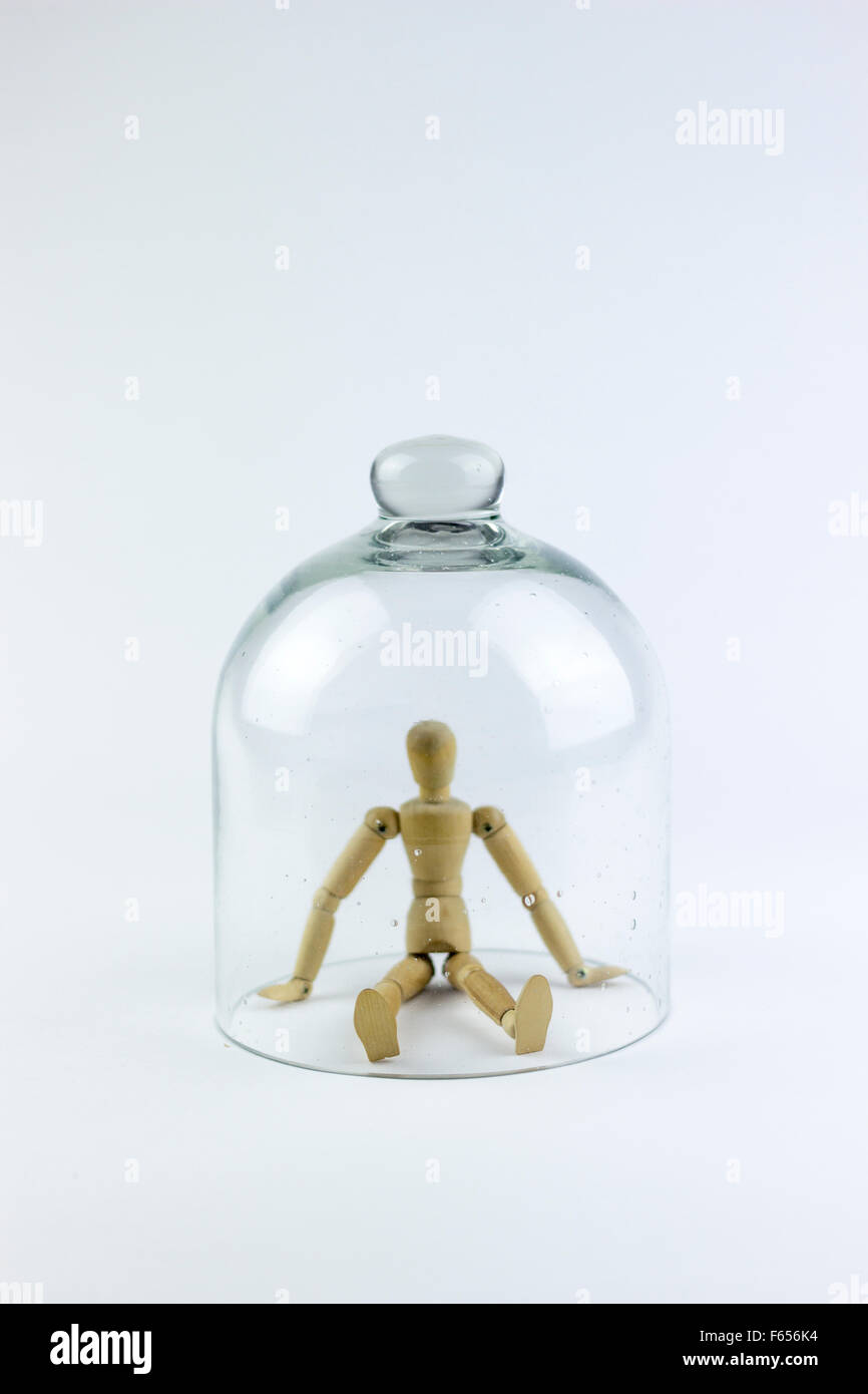 Wooden puppet trapped in a glass bell cage, on a white background Stock ...