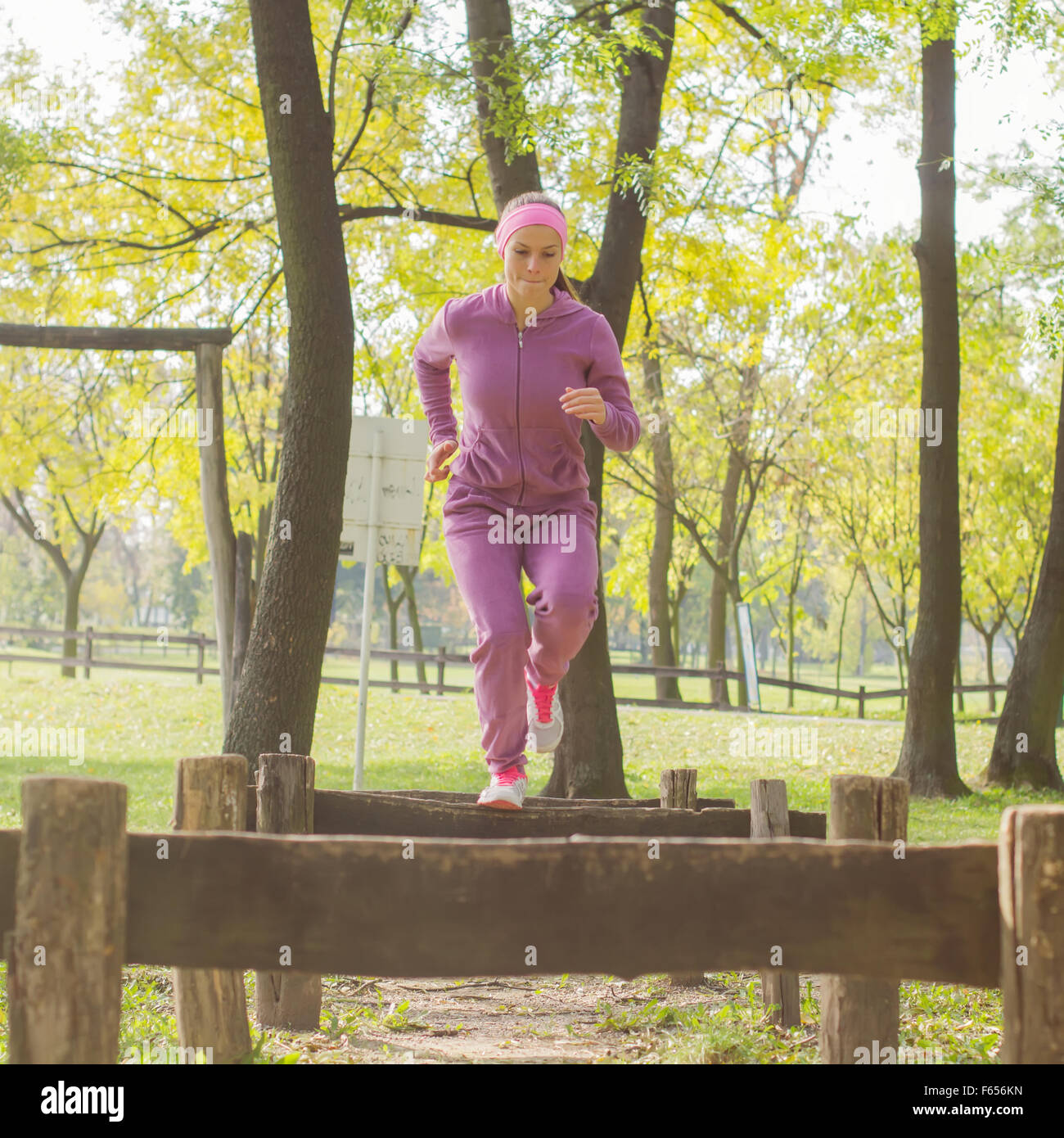 Fitness Young Woman Exercising ,Training Outdoor, jumping over hurdles ...