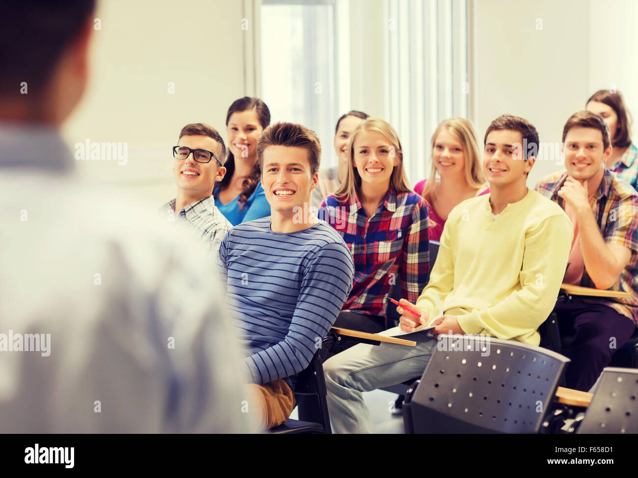 group of students and teacher with notebook Stock Photo - Alamy