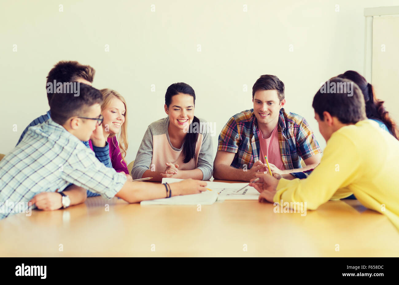 group of smiling students with blueprint Stock Photo - Alamy