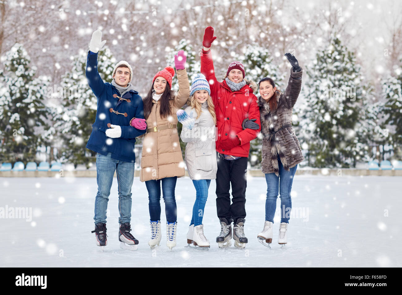 happy friends ice skating on rink outdoors Stock Photo - Alamy