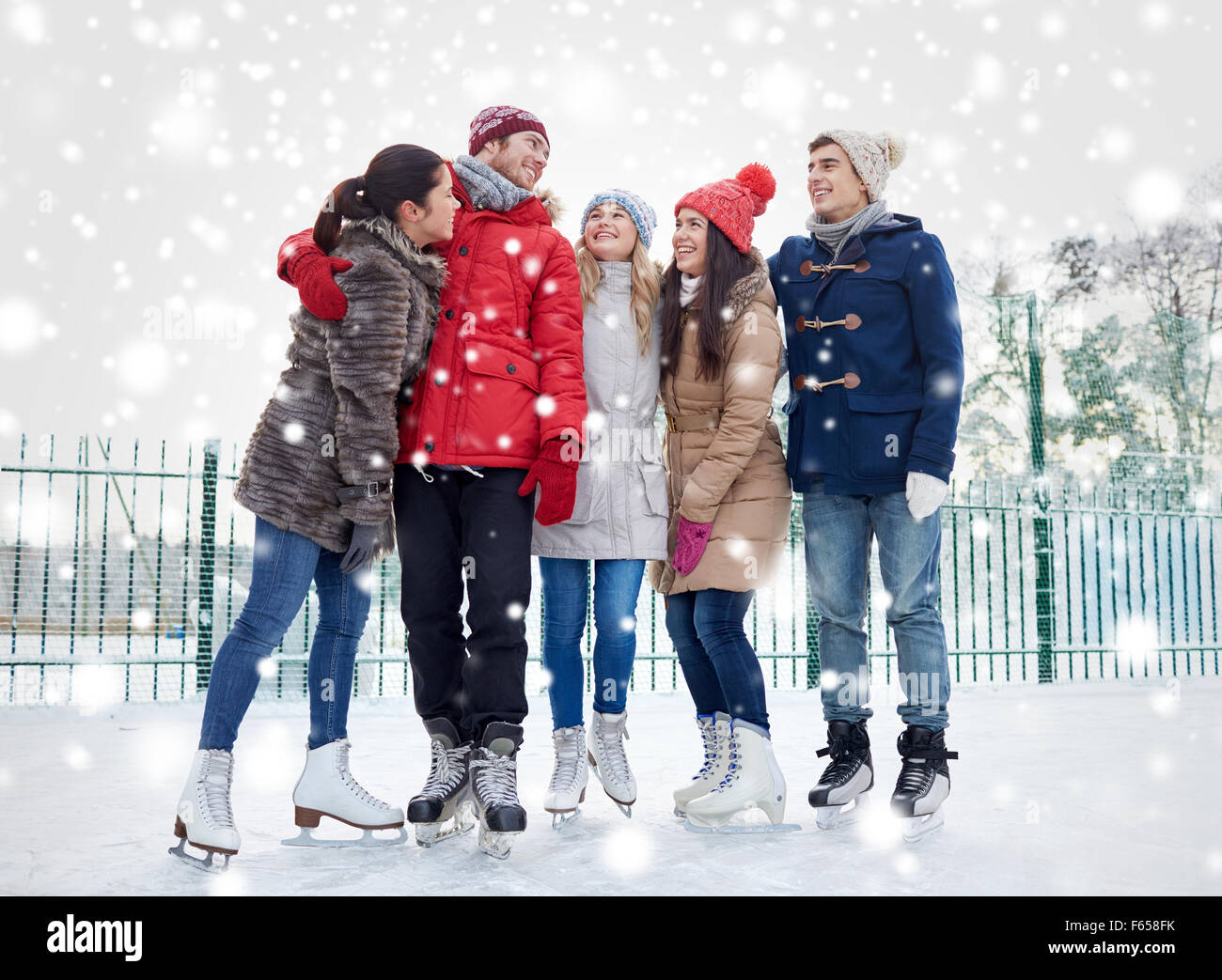happy friends ice skating on rink outdoors Stock Photo - Alamy