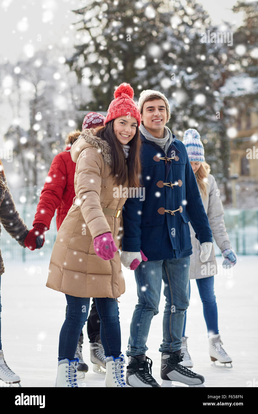 happy friends ice skating on rink outdoors Stock Photo - Alamy
