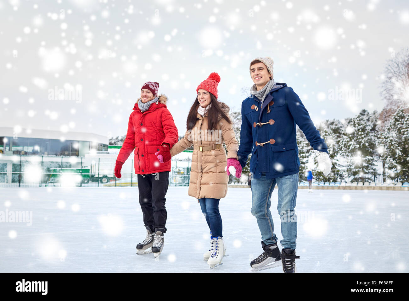 happy friends ice skating on rink outdoors Stock Photo - Alamy