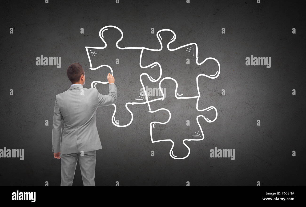 businessman drawing puzzle Stock Photo - Alamy