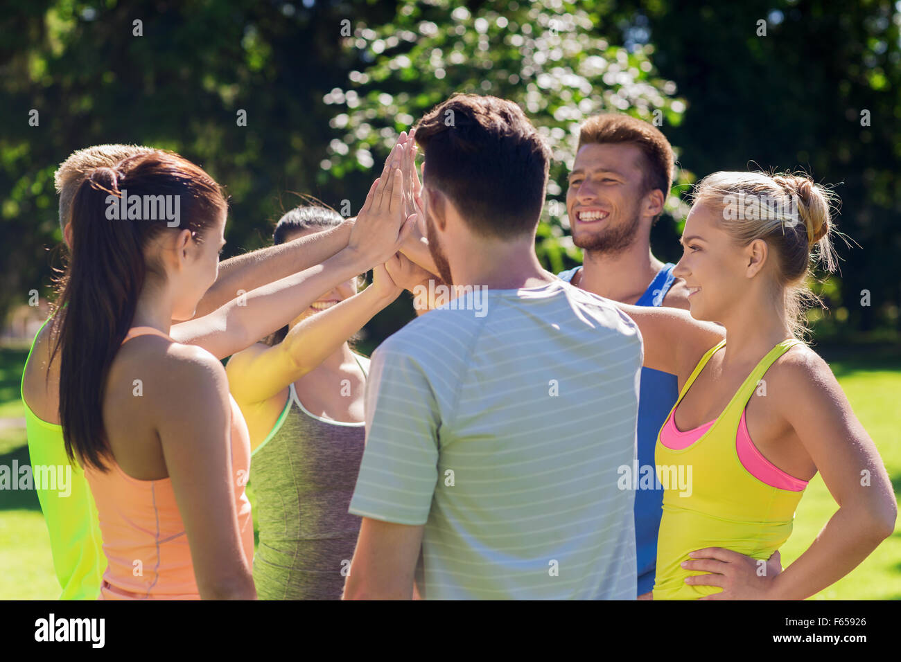 group of happy friends making high five outdoors Stock Photo - Alamy